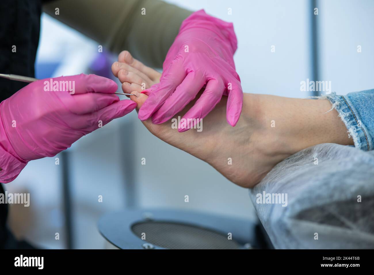 Podiatrist makes a pedicure to a client. The master conducts hygiene of ...
