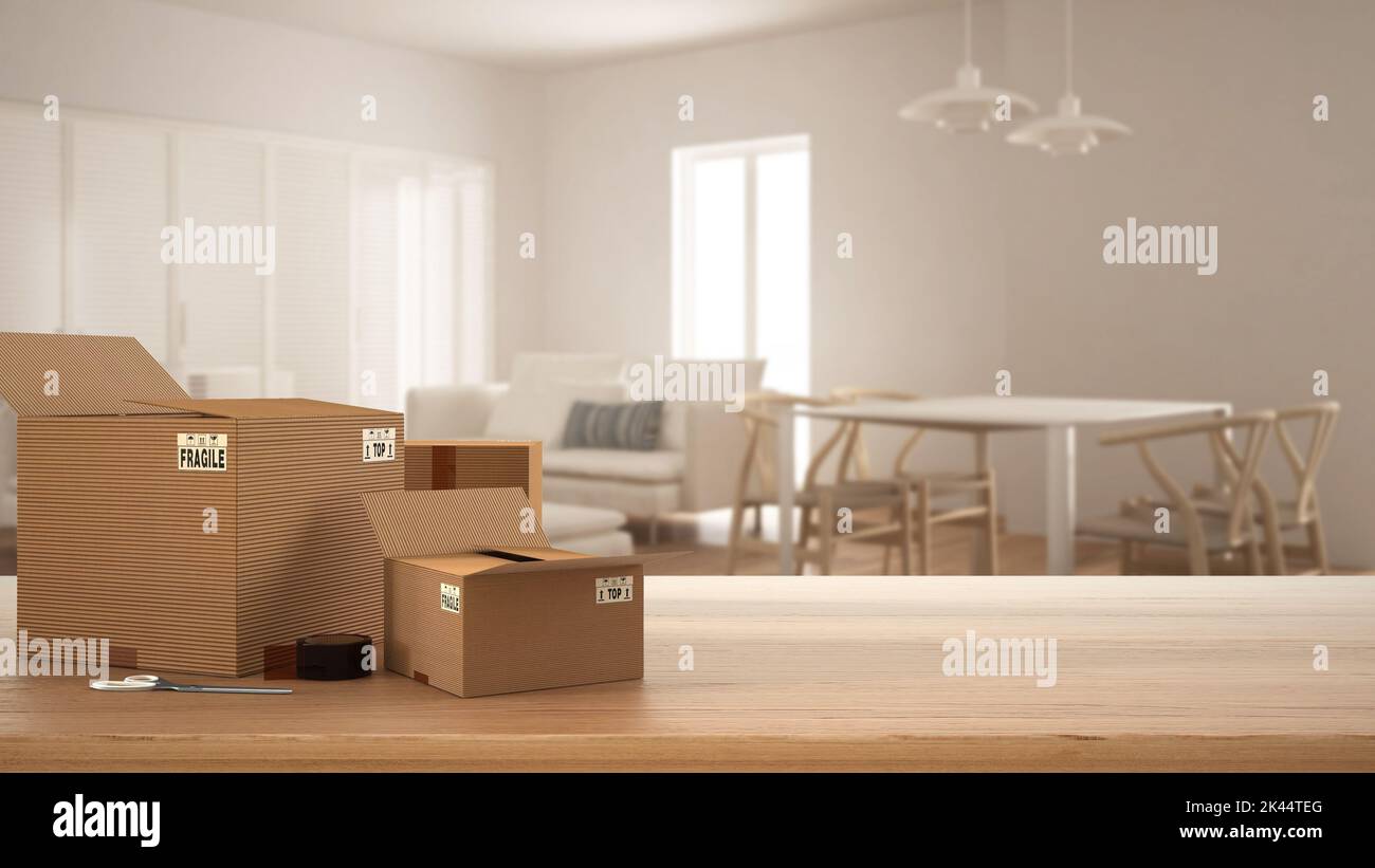 Wooden table, desk or shelf with stack of cardboard boxes over blurred ...