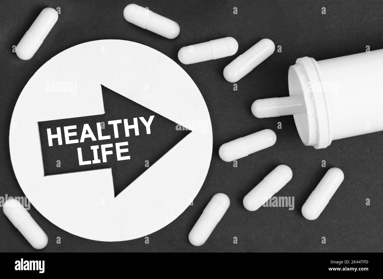 Medicine concept. Pills on a black background. They are indicated by a ...