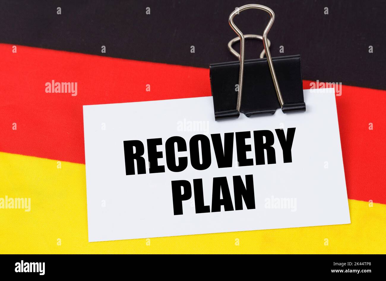 National economy concept. On the flag of Germany lies a notebook with ...