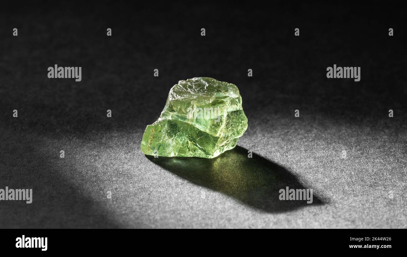 Translucent green Apatite crystal healing stone on dark background ...