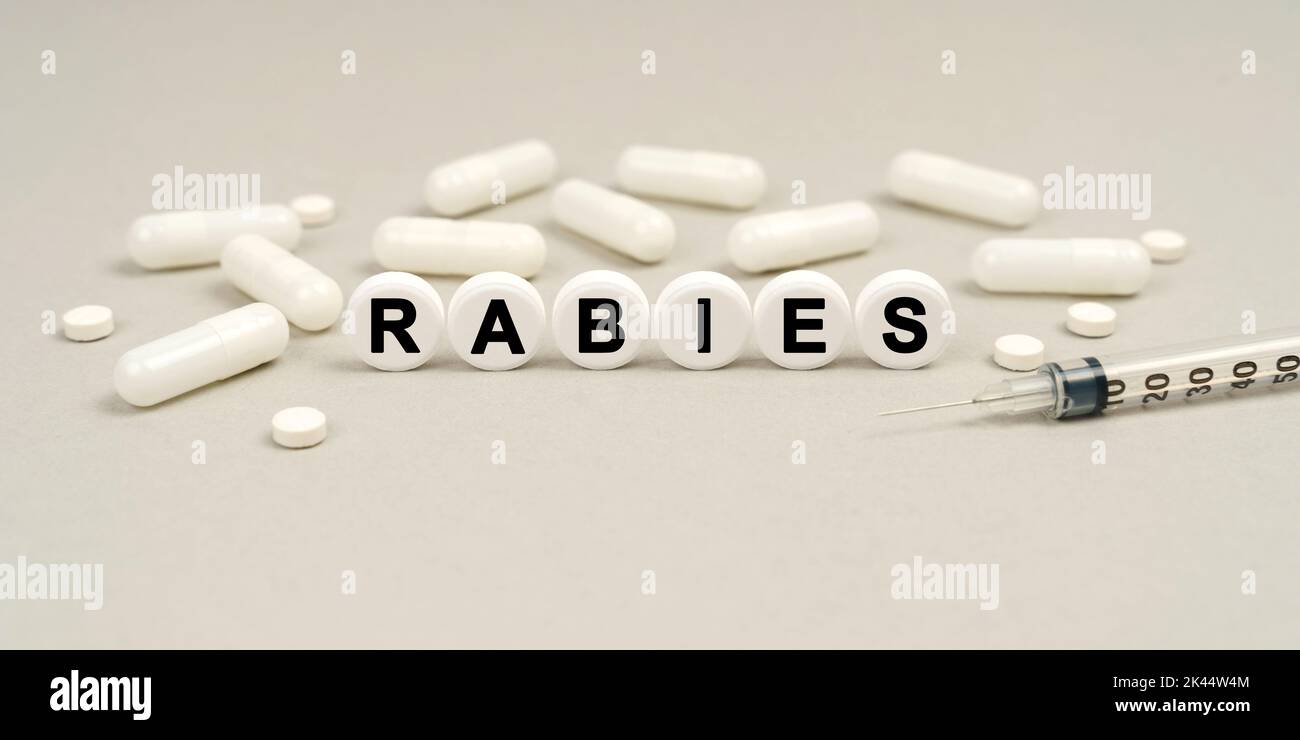 Medicine concept. On the table are capsules, a syringe and pills that ...