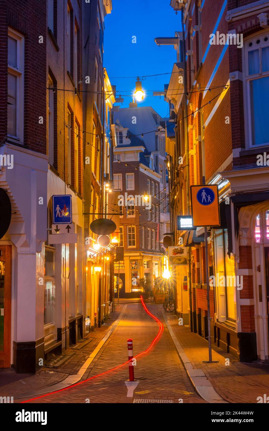 Netherlands. Summer night in downtown Amsterdam. Empty narrow street ...