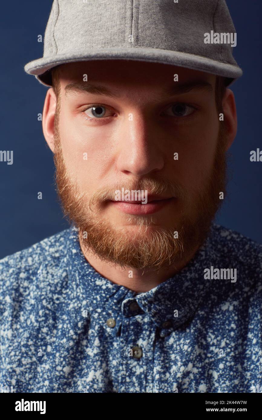 Open and honest gaze. A young man with a beard and unique sense of ...
