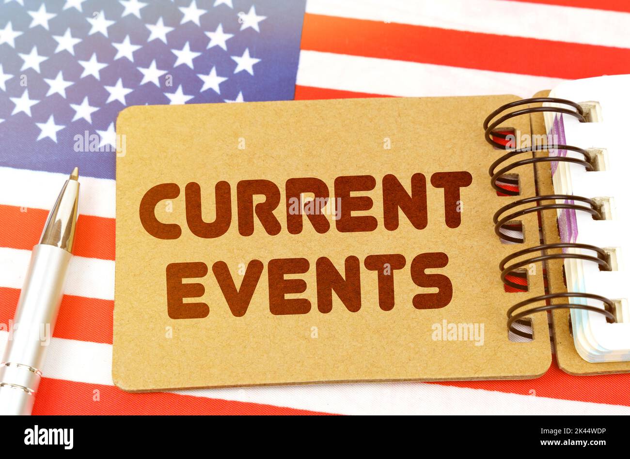 National economy concept. On the US flag lies a notebook with the ...