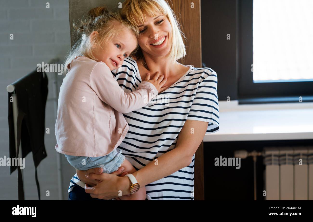 Loving single mother hugs cute daughter feel tenderness connection ...