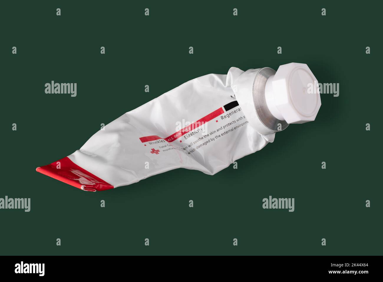 A photo of healthcare product and tube of cream with shadow and green ...