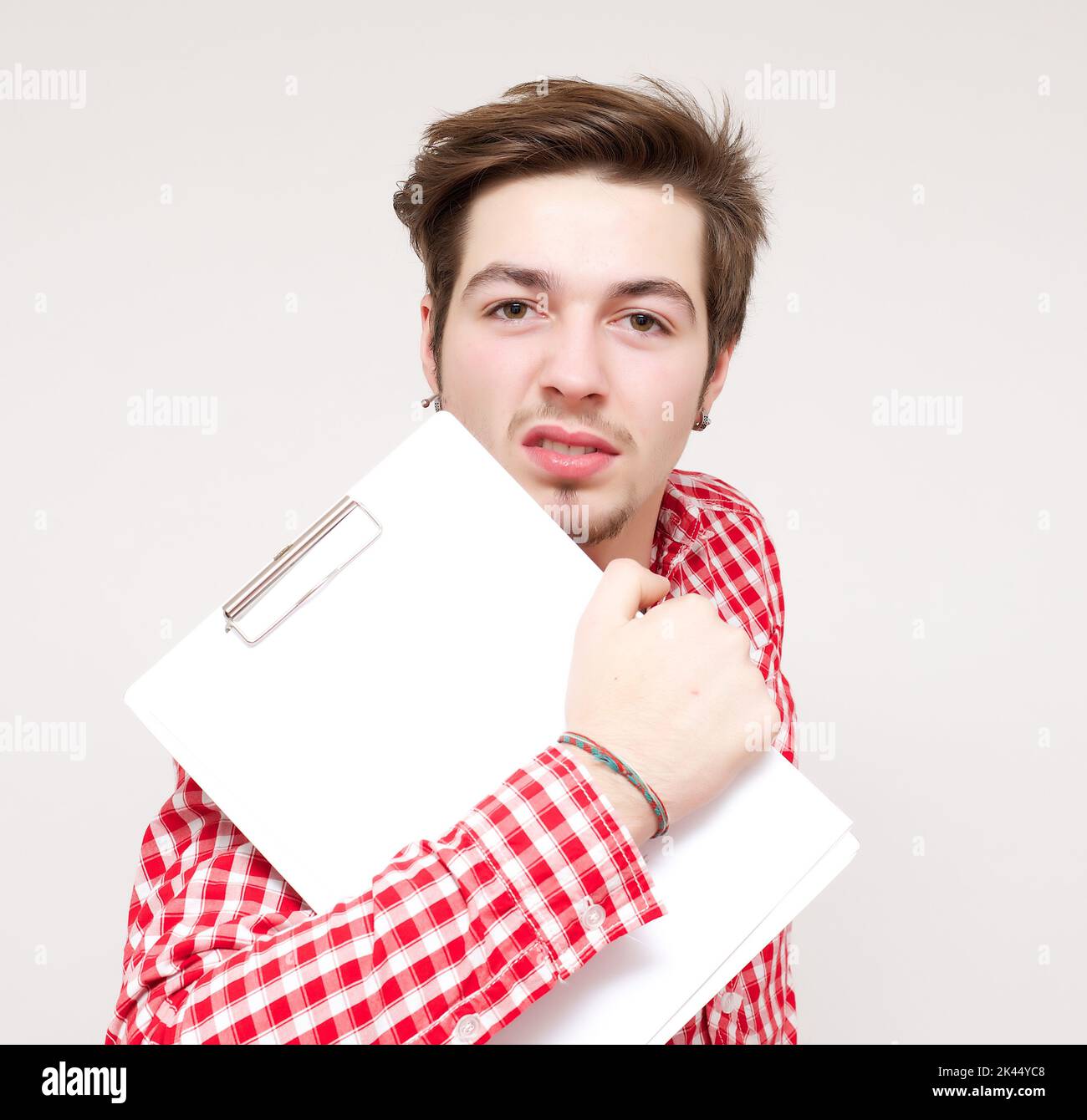 Young man with red shirt and blank board isolated on white stock photo ...