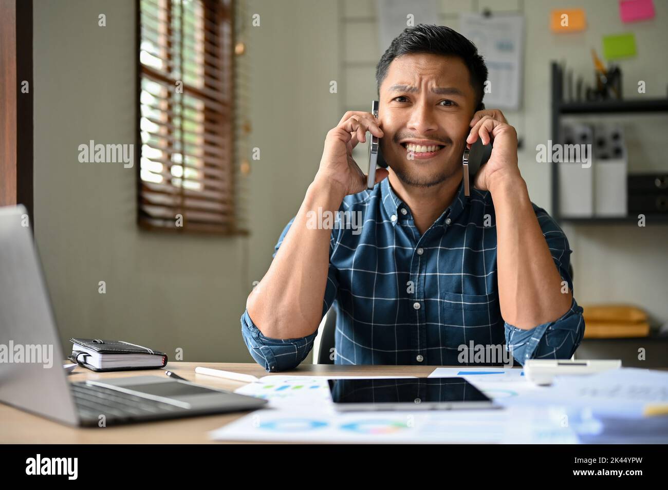 Confused and busy millennial Asian businessman or male office worker ...