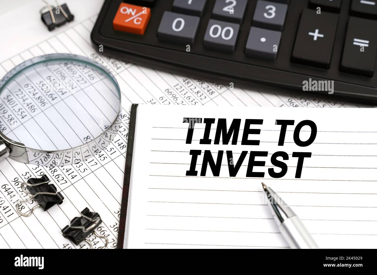 Business concept. On the table is a magnifying glass, a calculator, a ...