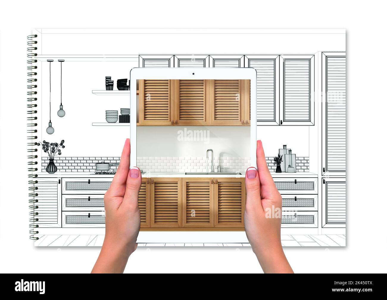 Hands holding tablet showing wooden kitchen, notebook with blueprint ...