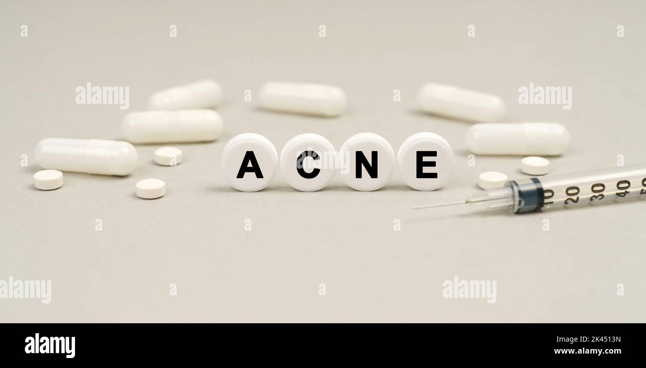 Medicine concept. On the table are capsules, a syringe and pills that ...