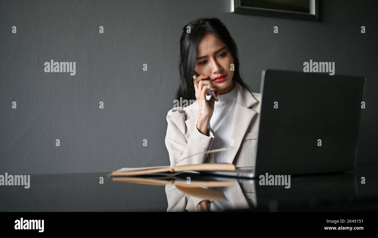 Stressed millennial Asian businesswoman or female manager having a ...