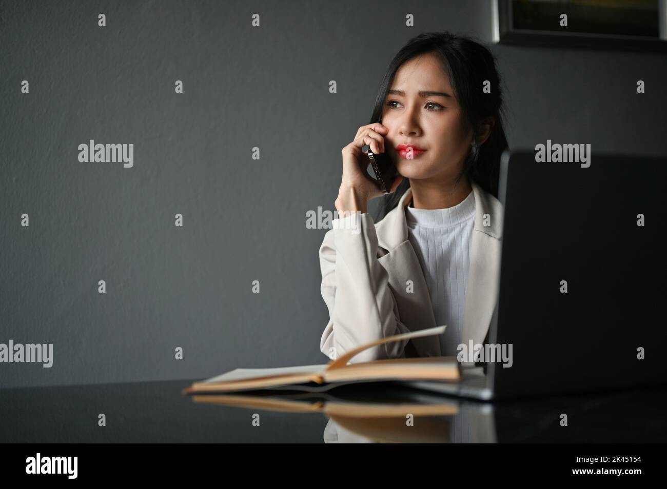 Stressed millennial Asian businesswoman or female manager having a ...