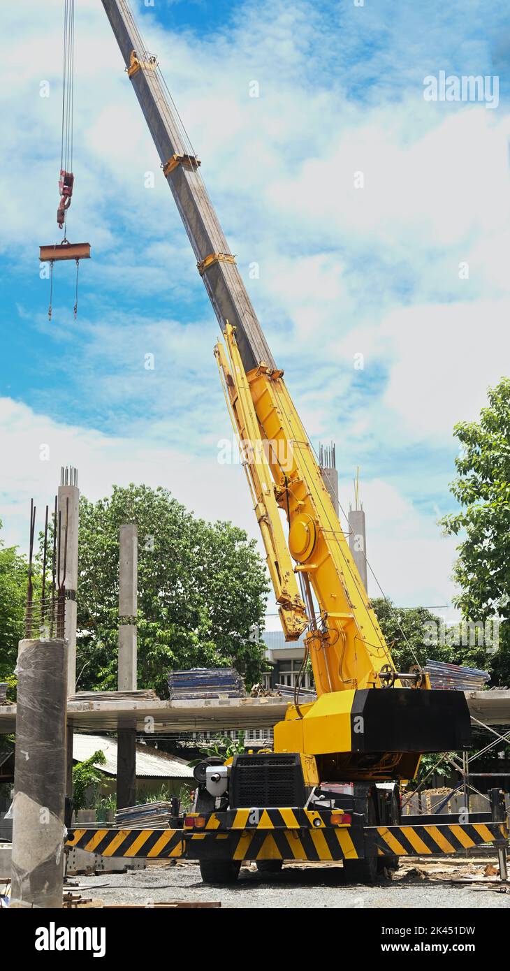 Mobile crane lifting steel structure above the unfinished residential ...