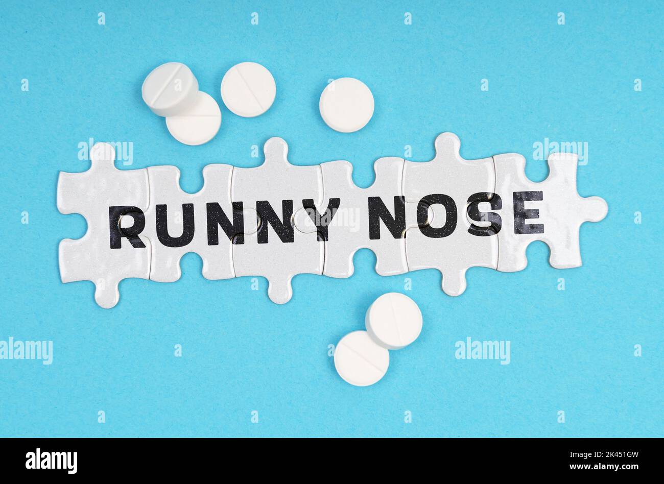 Medicine concept. On a blue background pills and puzzles with the ...
