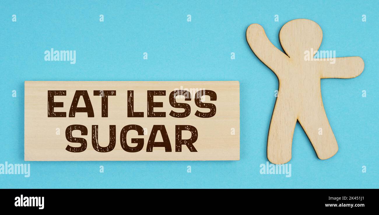 Medicine concept. On a blue background, a wooden figure of a man and a ...