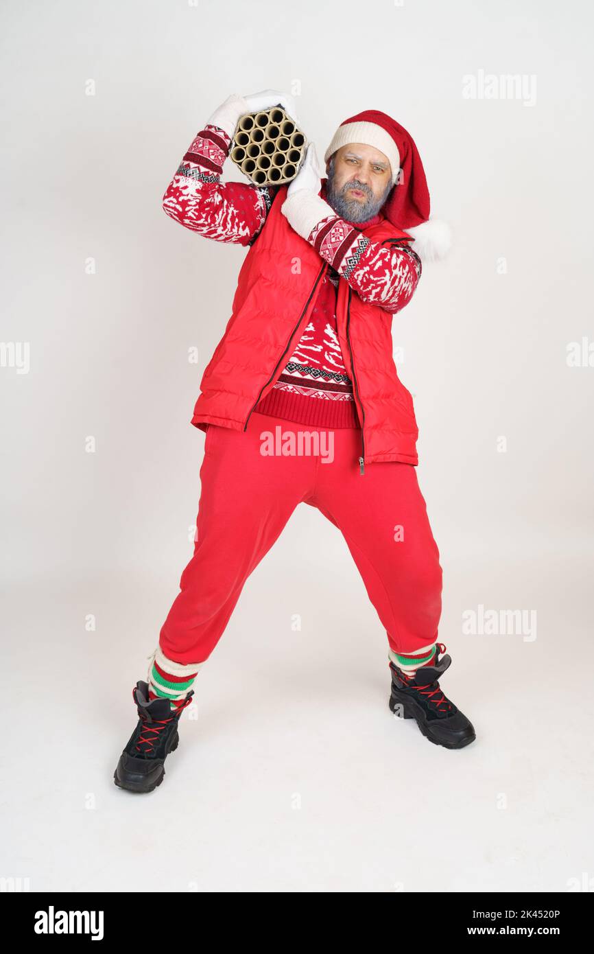 Christmas and New Year concept. Santa Claus holds fireworks in his ...