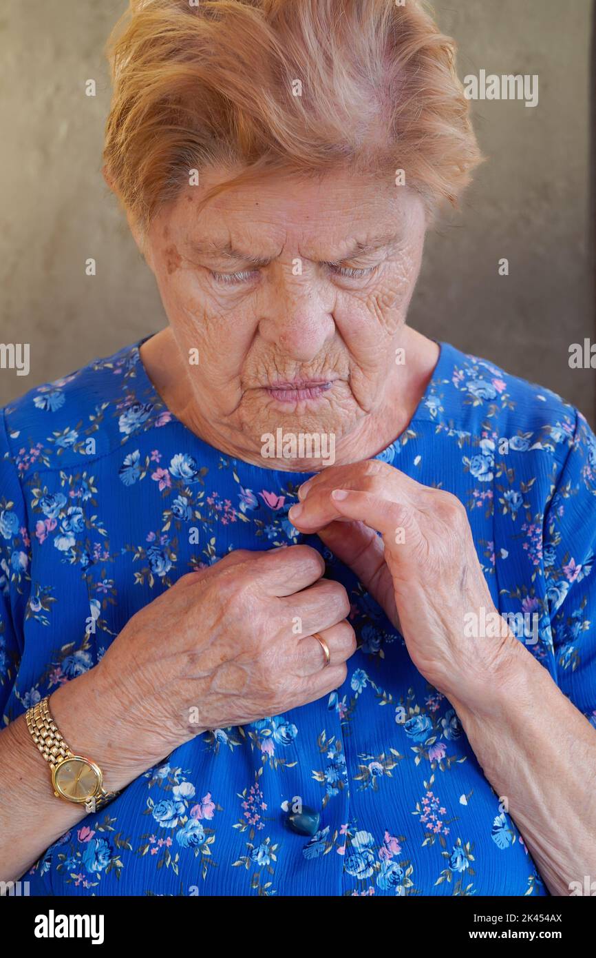 elderly woman disabled woman getting dressed. Apraxia. loneliness in ...