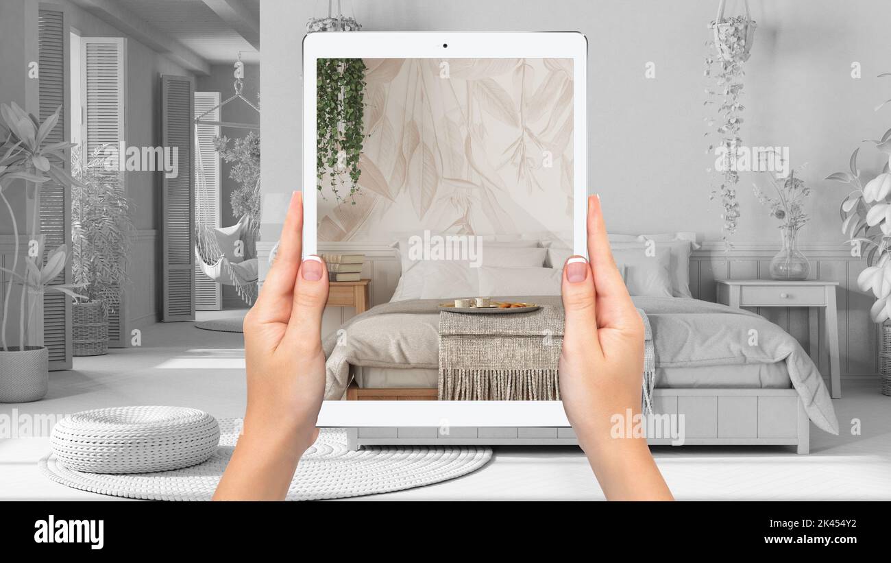Hands holding tablet showing bohemian bedroom in boho style, total ...