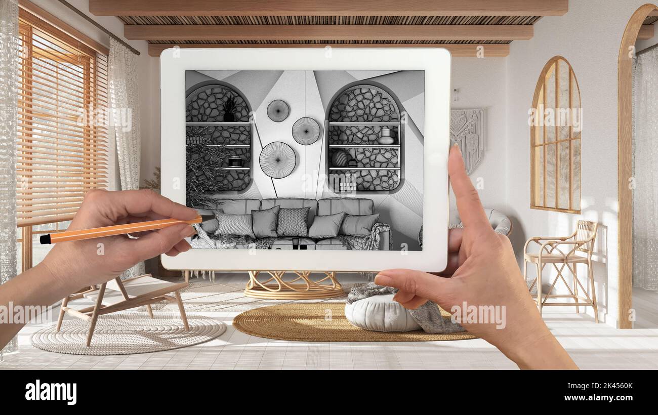 Hands holding and drawing on tablet showing bohemian living room in ...