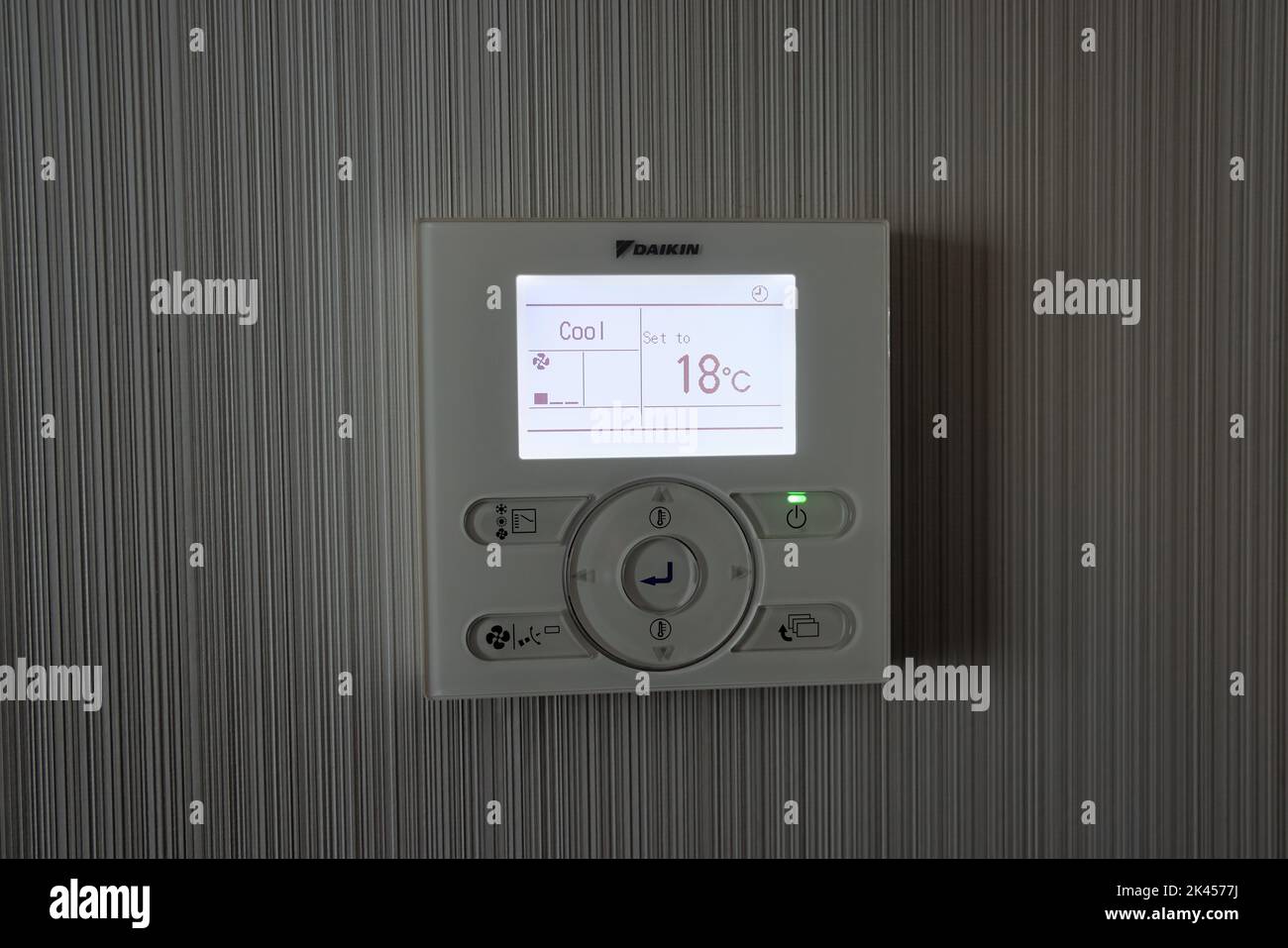 Room thermostat set to 18 degrees for cooling; concept of (saving on ...