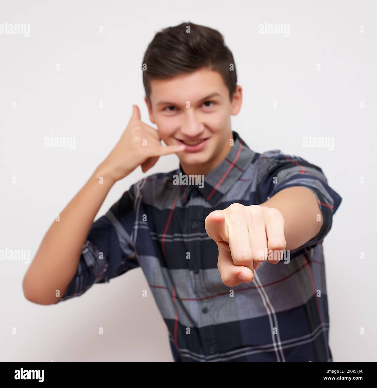 Handsome young businessman making a "call me" hand gesture Stock Photo ...