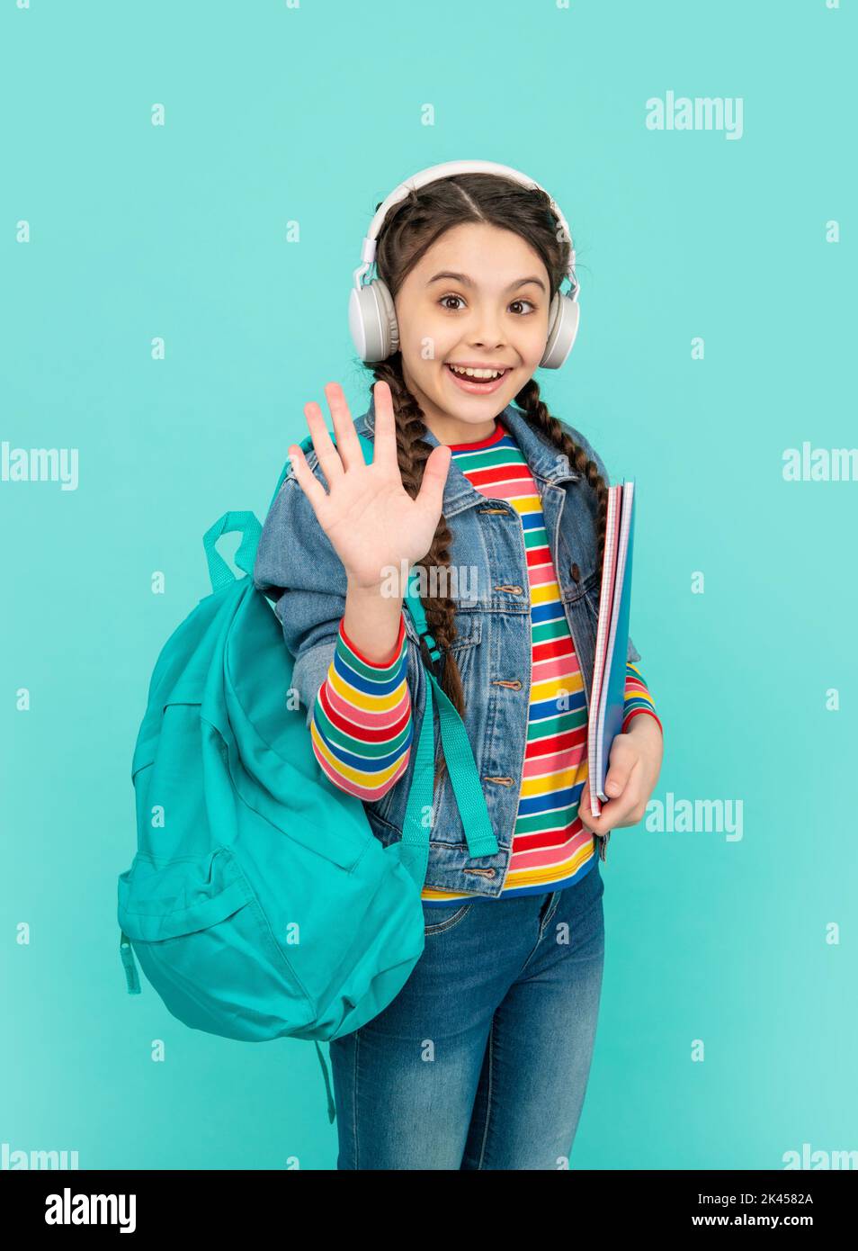 Hello school. Happy teen girl waving hand blue background, school. Back ...