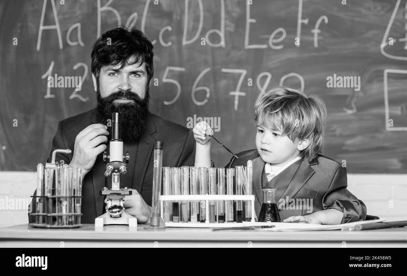 I love study in school. Teacher and pupil boy in chemical laboratory ...