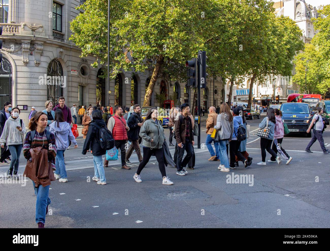 Tourists crossing on a marked crossing place in the Strand, central ...