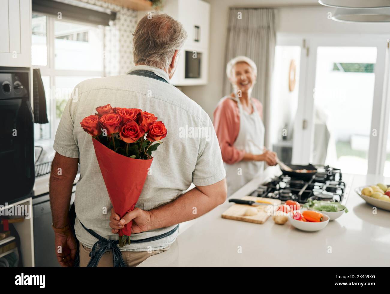 Roses, gift and senior couple love flowers to celebrate their marriage ...