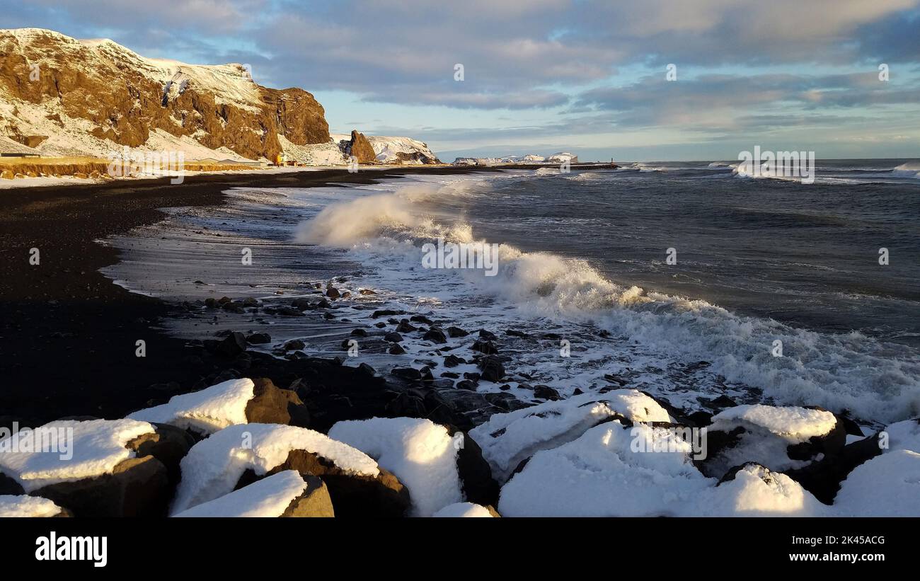A beautiful view of a snowy coast under cloudy sky Stock Photo - Alamy