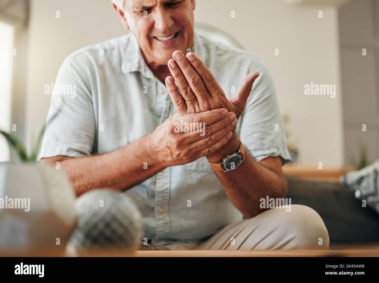 Senior man, hands and wrist joint pain in living room home from carpal tunnel, osteoporosis and ...