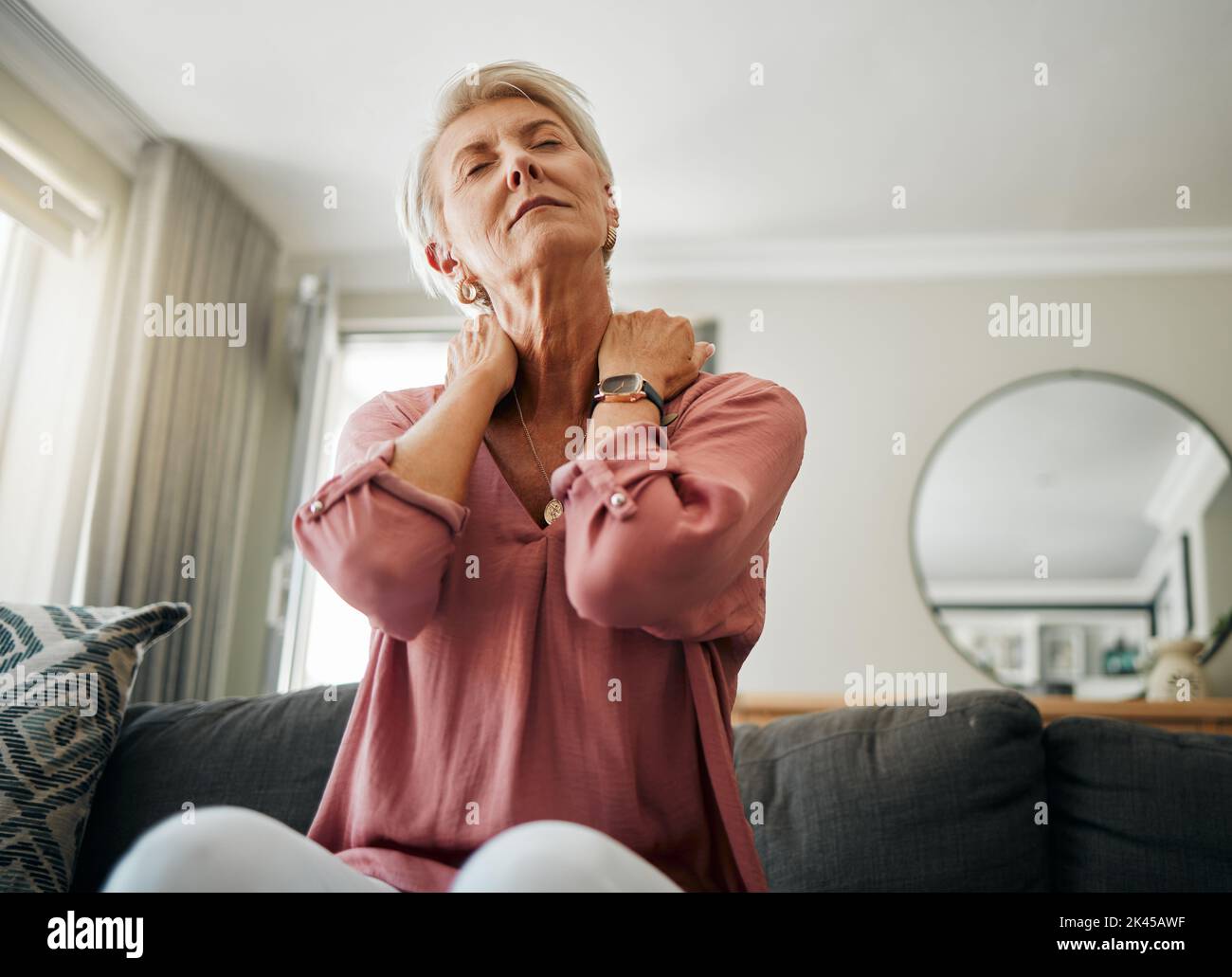 Senior woman, neck pain and stress in living room home of spine injury ...