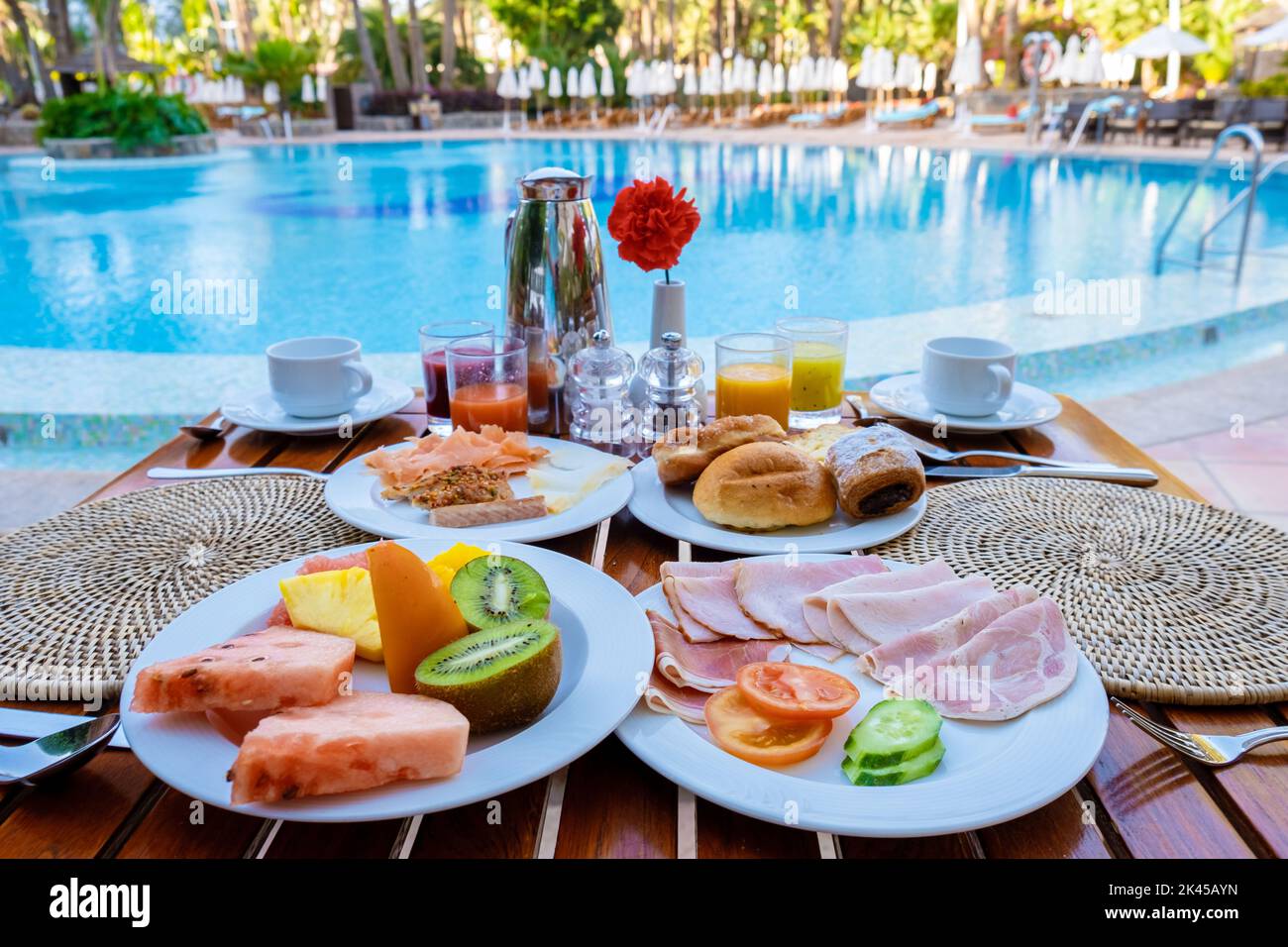 colorful breakfast by a pool of a luxury resort. breakfast with ...