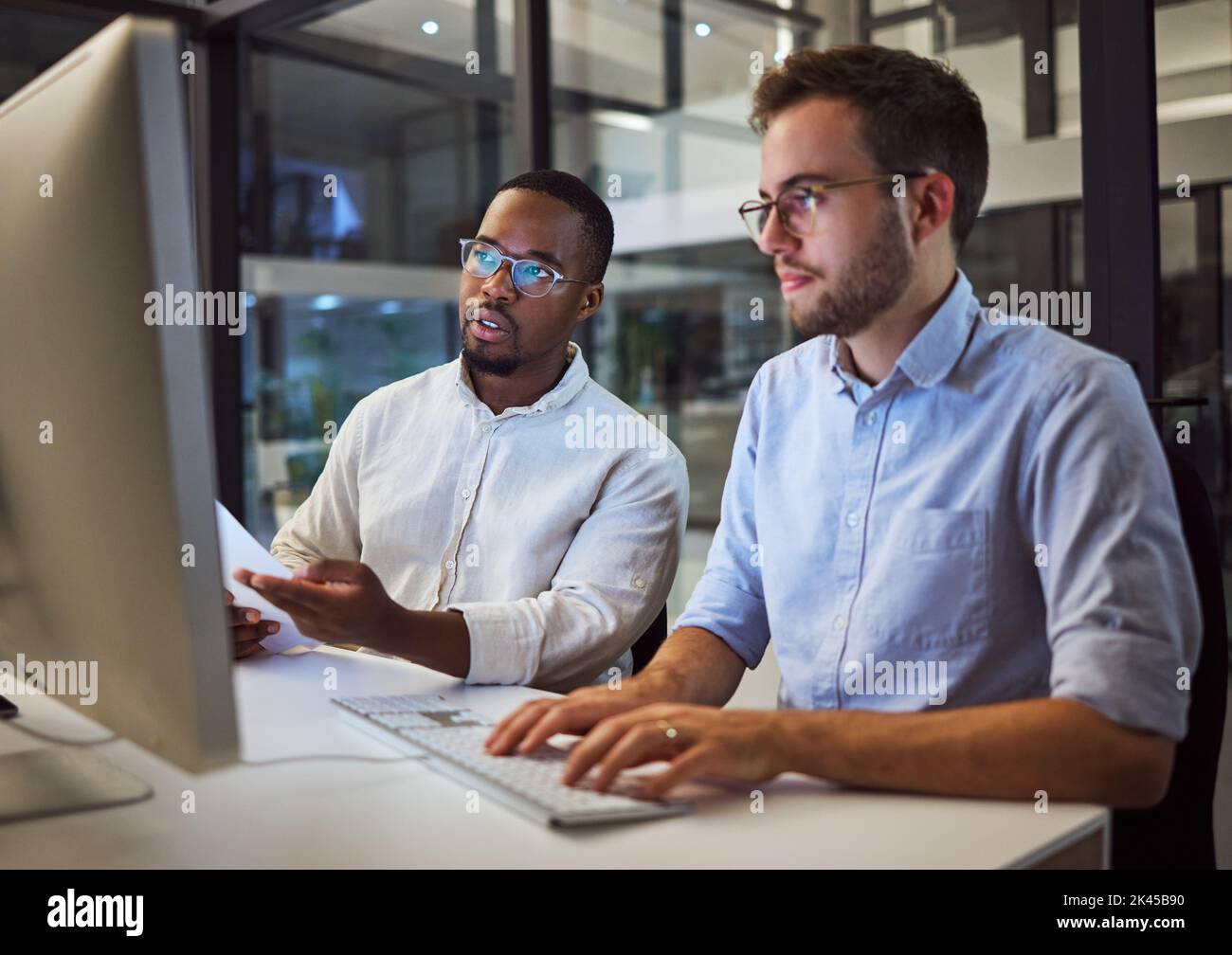 Marketing team at night, working on digital advertising project with ...