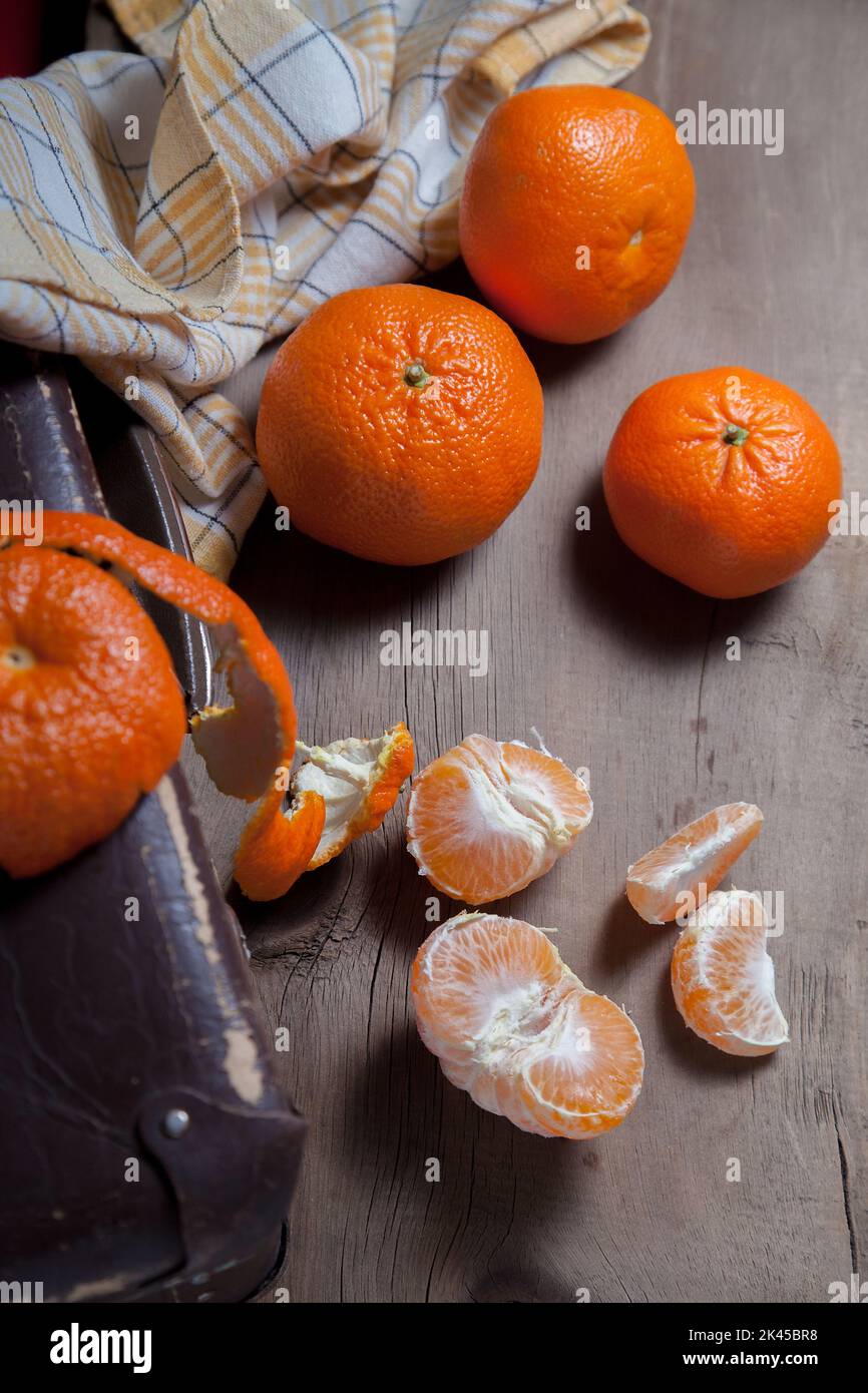 Several of unpeeled whole fresh orange mandarine or oranges, tangerines, clementines, citrus ...