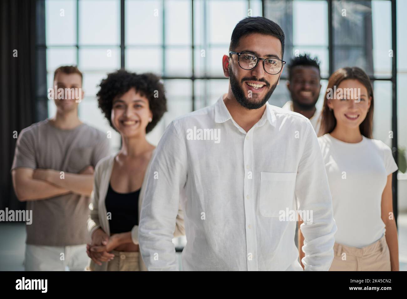 Smiling professional business leaders and employees group team portrait ...