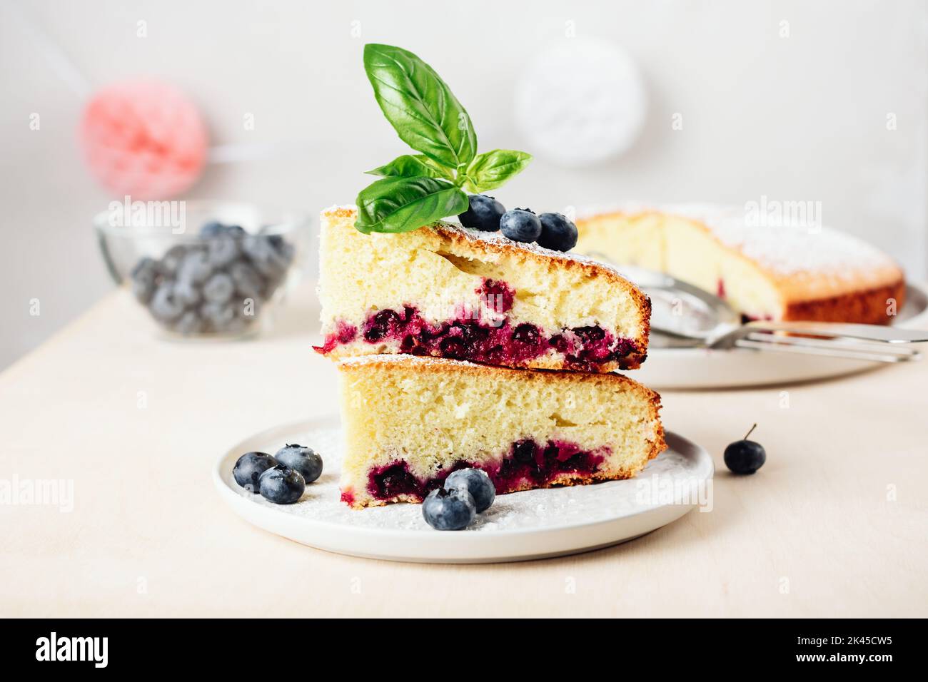 Blueberry lemon sponge cake in a plate, close-up Stock Photo - Alamy