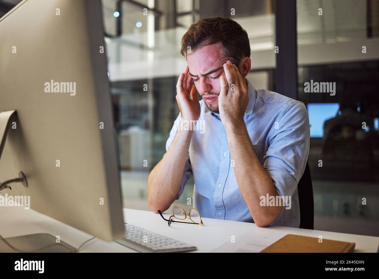 Stress, depression and mental health for night business man sitting at his computer desk with ...