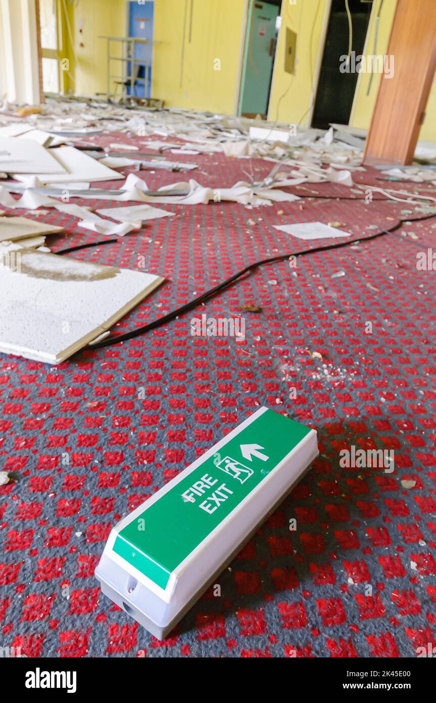 Fire exit sign lies on the floor in an abandoned office building Stock ...