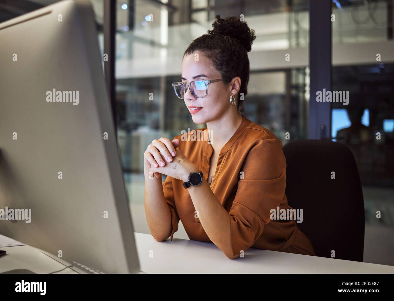 Night, research and report with a business woman working on a computer ...