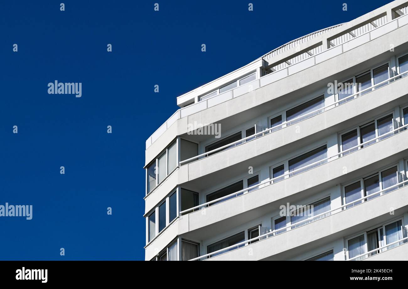 Corner of a block of flats apartments with blue sky backdrop on ...