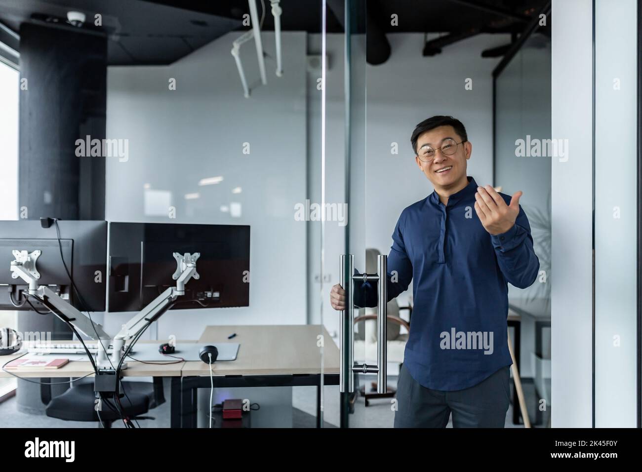 A successful engineer programmer boss invites to his office, an Asian ...