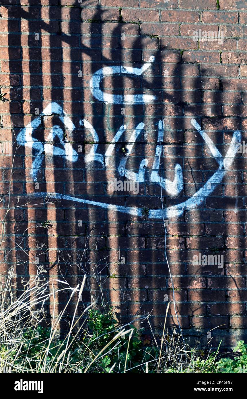 graffiti and fence shadow on vintage brick wall Stock Photo - Alamy