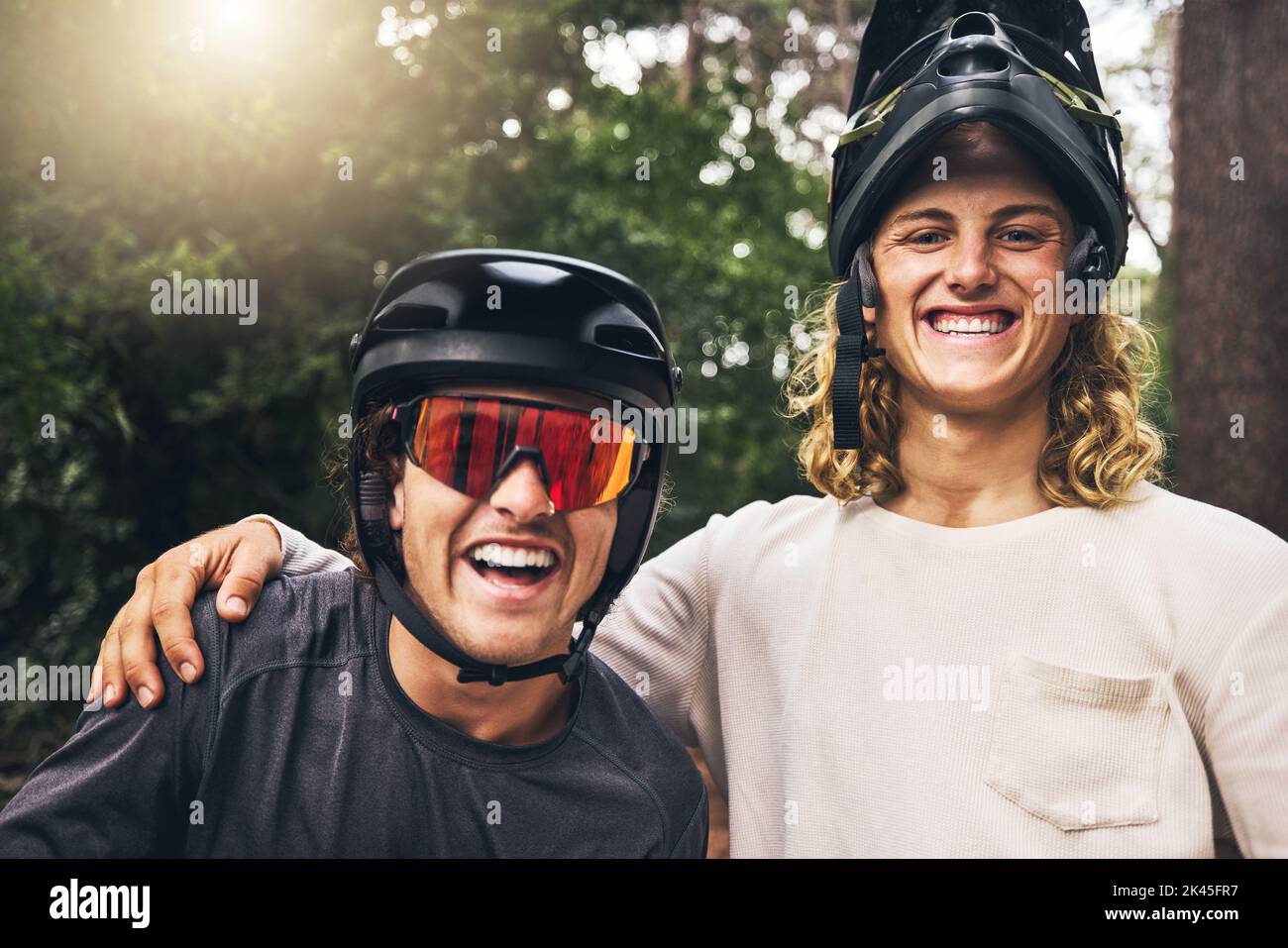 Friends taking a selfie together after cycling through nature trail in ...