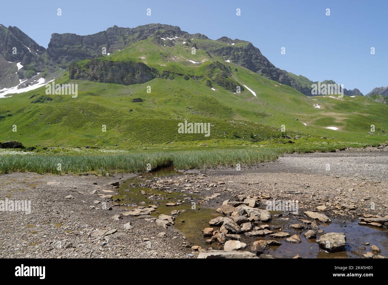 Mountain brook or stream opening into a dried up lake Stock Photo - Alamy