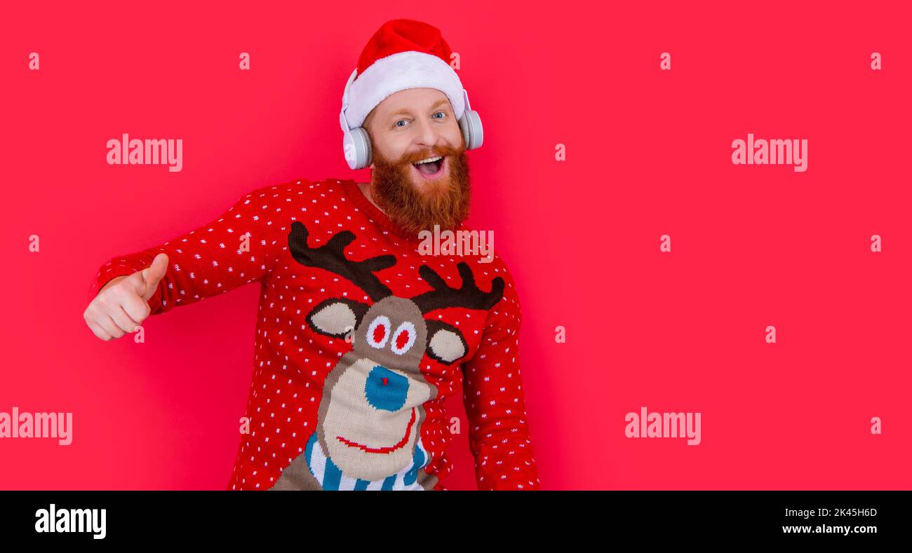 cheerful bearded man celebrate christmas with music. man in headphones ...