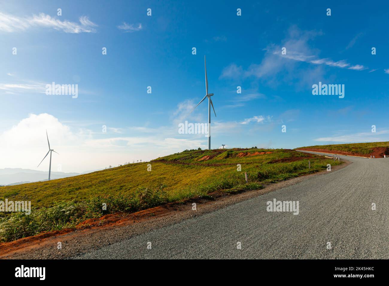 Renewable energy wind turbines windmill isolated on the beautiful blue ...