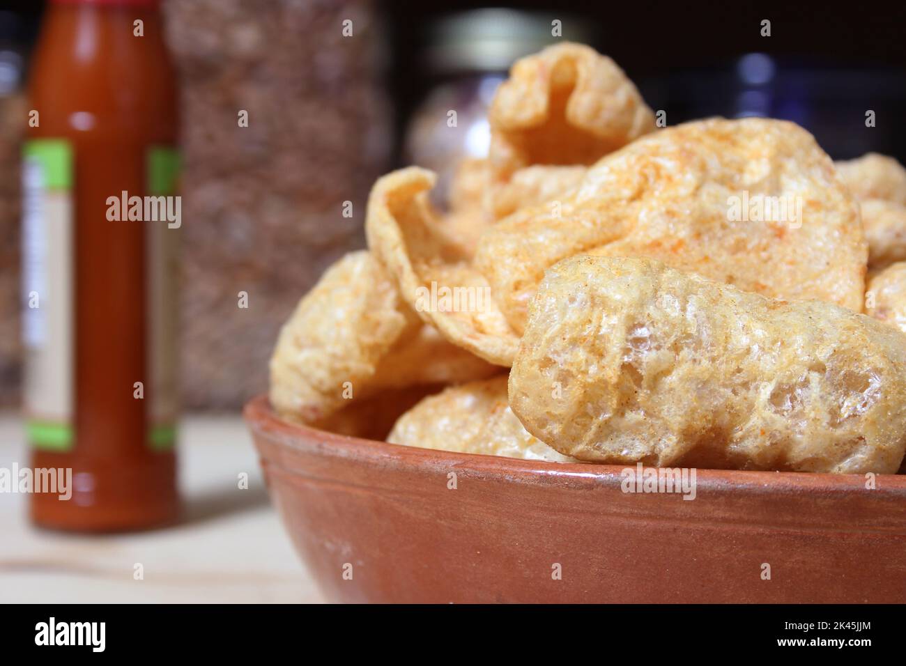 Fried Pork Rinds With Hot Sauce in Rustic Kitchen Stock Photo - Alamy
